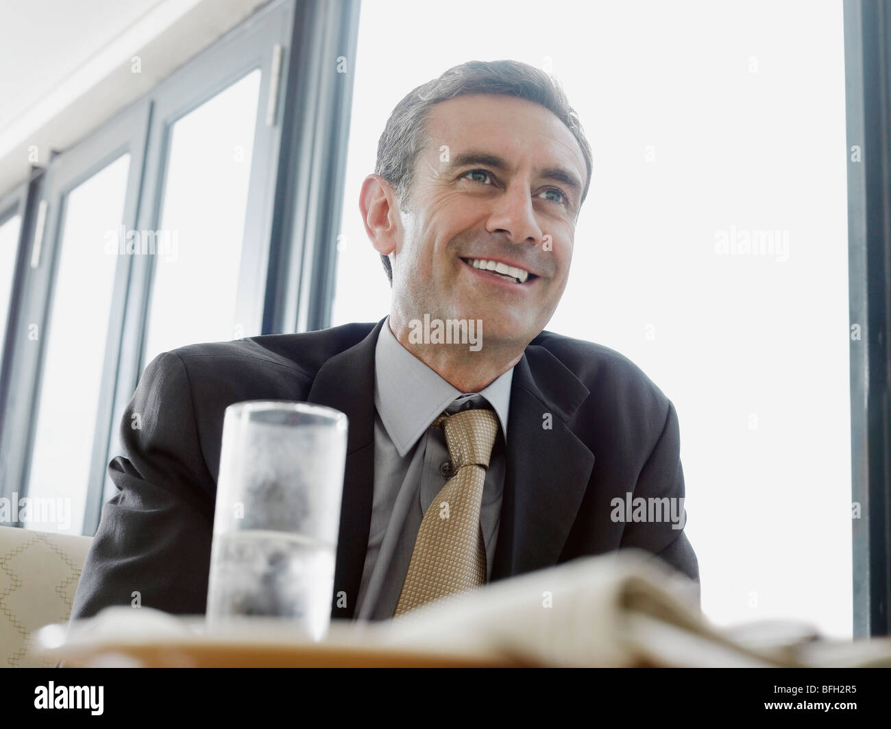 Businessman smiling in restaurant Stock Photo - Alamy