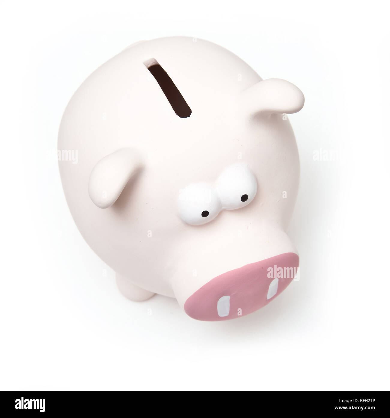 Pink piggy bank style money box isolated on a white studio background ...