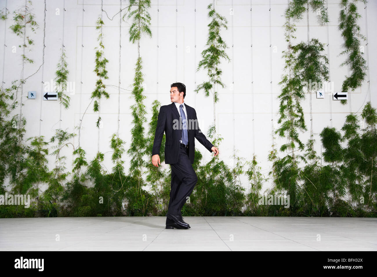 Businessman looking over shoulder, outdoors Stock Photo - Alamy