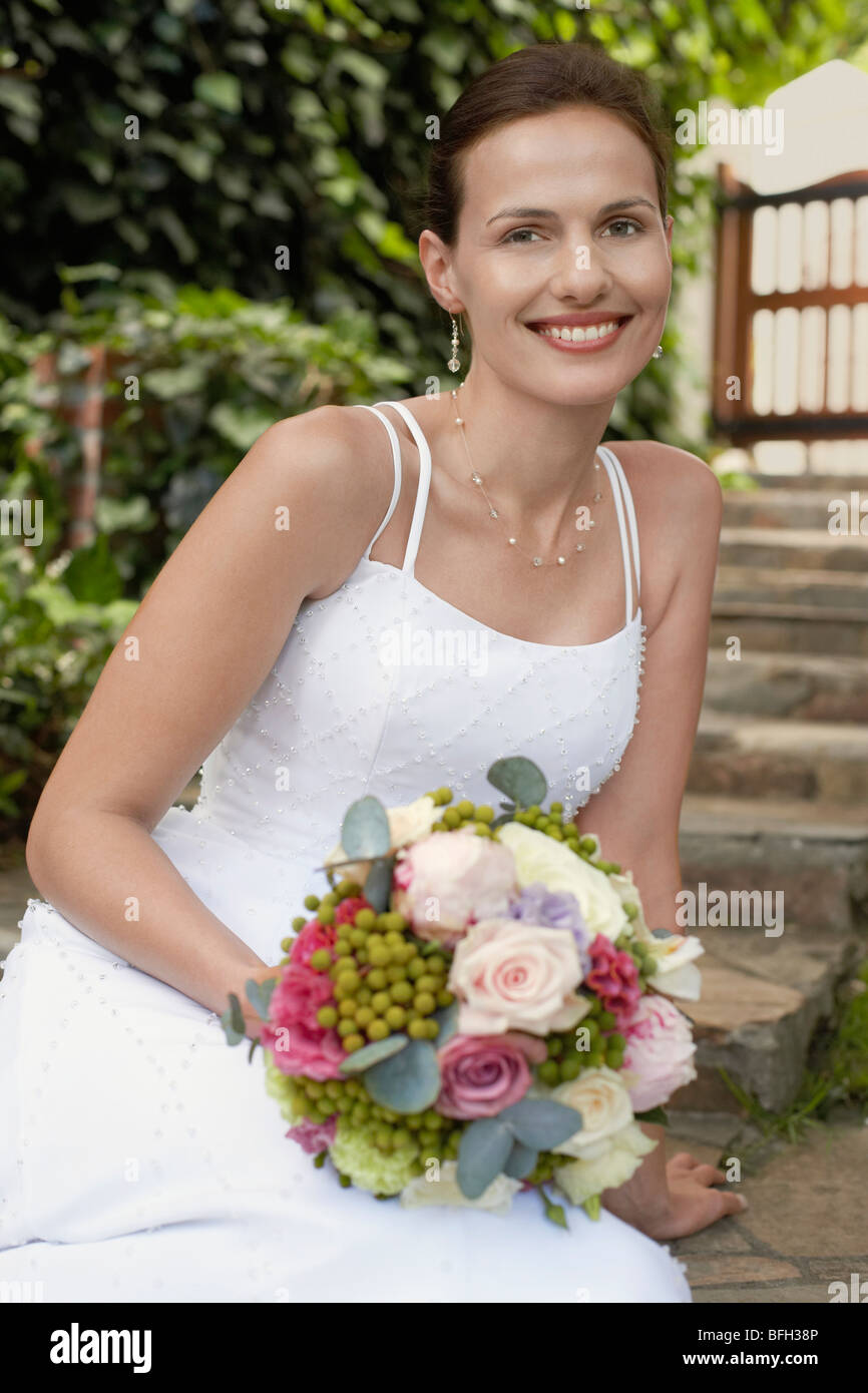 Mid Adult Woman Wearing White Dress Holding Bouquet Smiling Stock