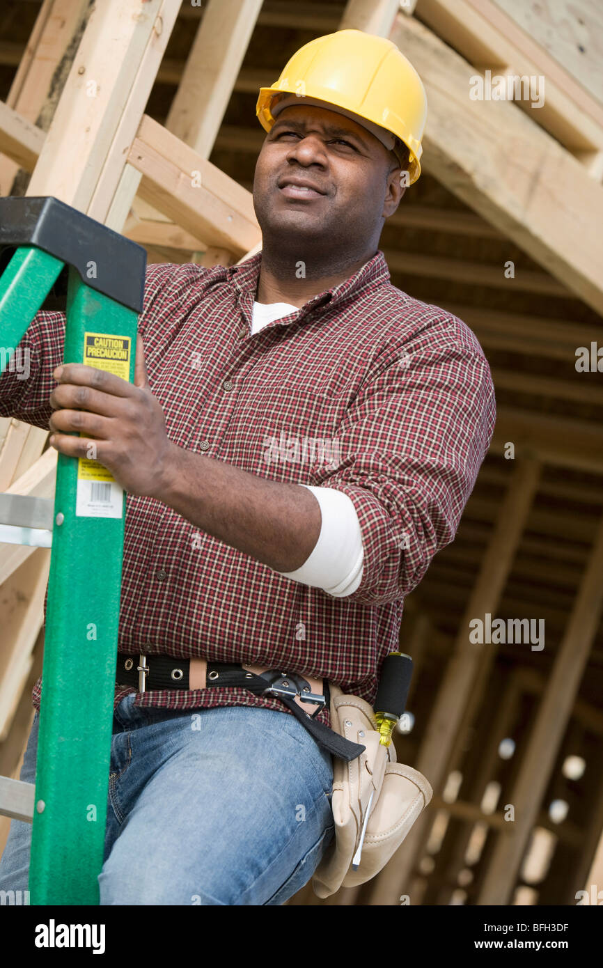 Construction worker climbing ladder Stock Photo - Alamy