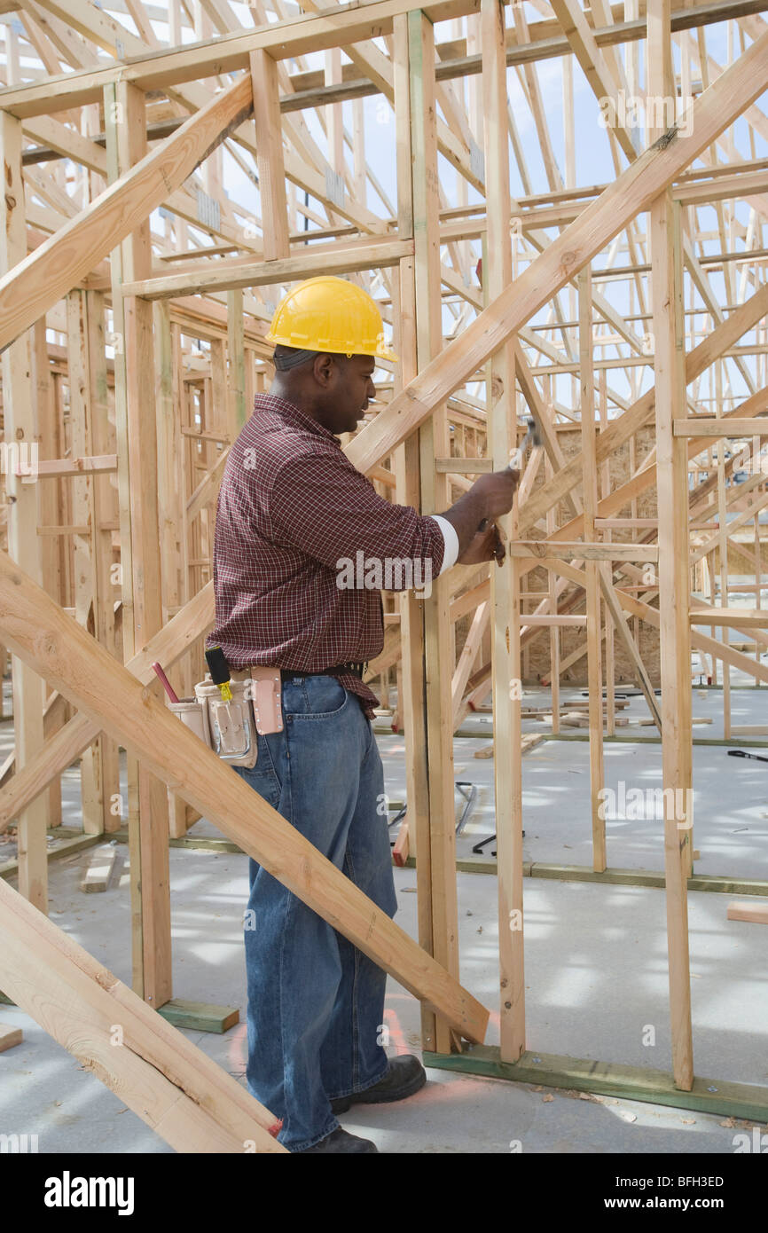 Construction worker hammering framework hi-res stock photography and ...