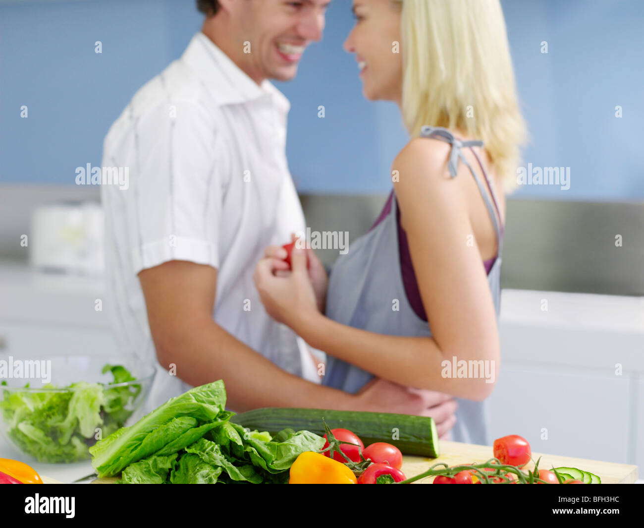 Young couple standing face to face, Flirting in Kitchen near fresh ...