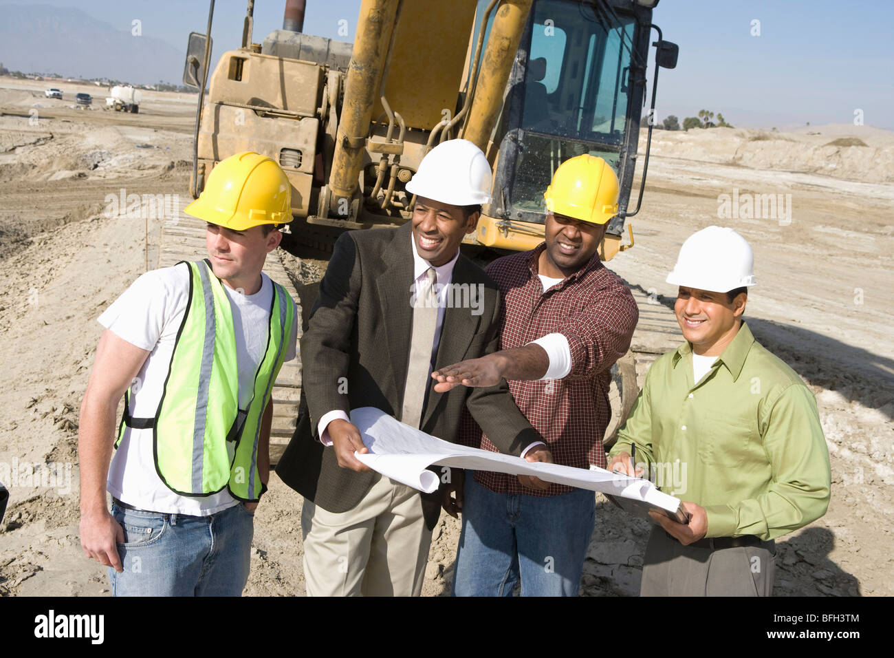 Surveyor and construction workers on site Stock Photo - Alamy
