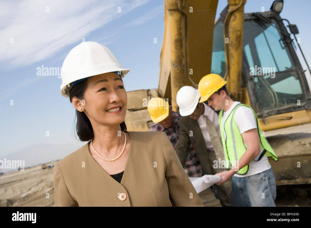 Female surveyor and construction workers on site Stock Photo - Alamy