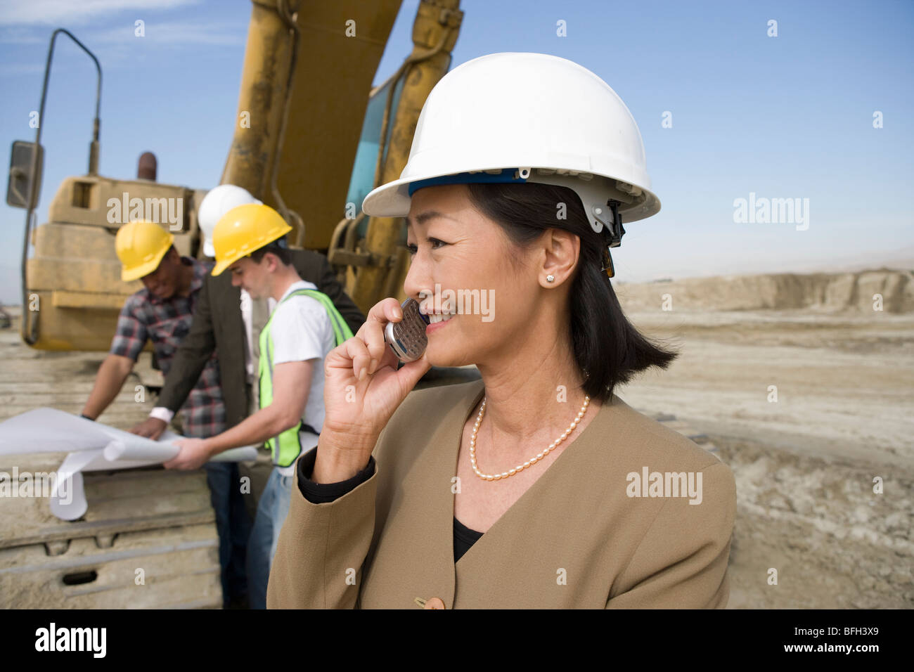 Female surveyor and construction workers on site Stock Photo - Alamy