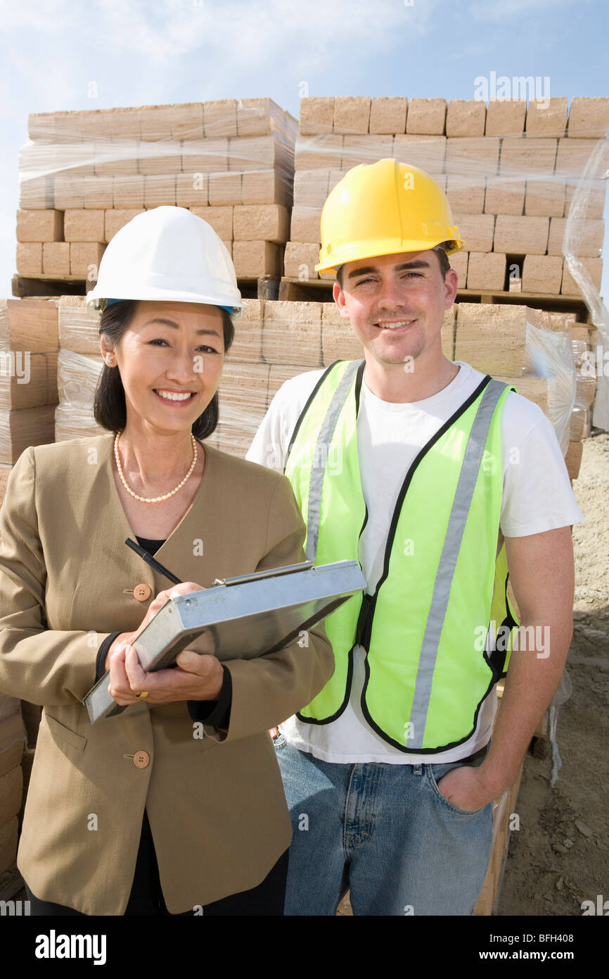 Architect and construction worker standing on construction site Stock ...