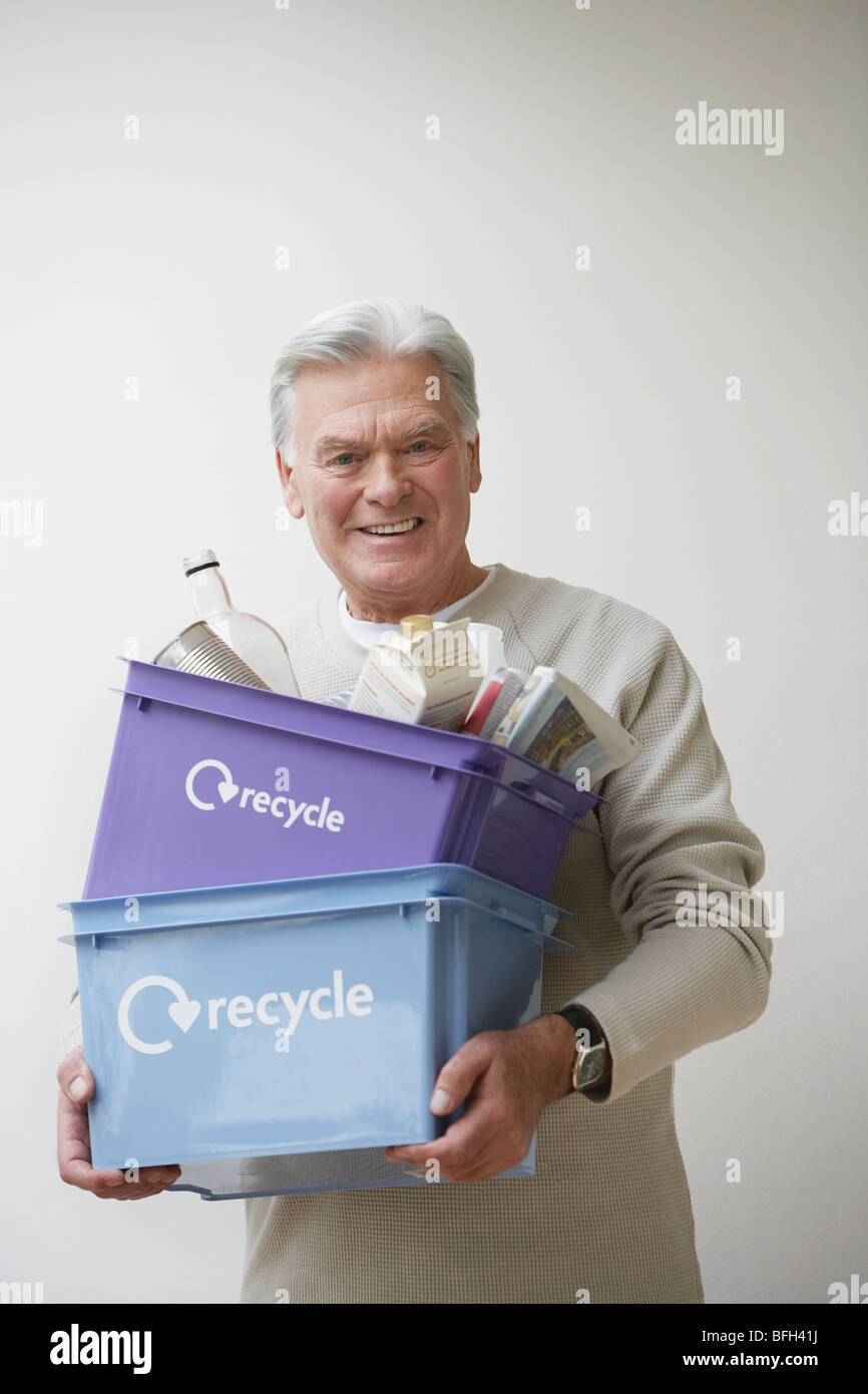 Senior Man Carrying Recycling Bin Stock Photo - Alamy