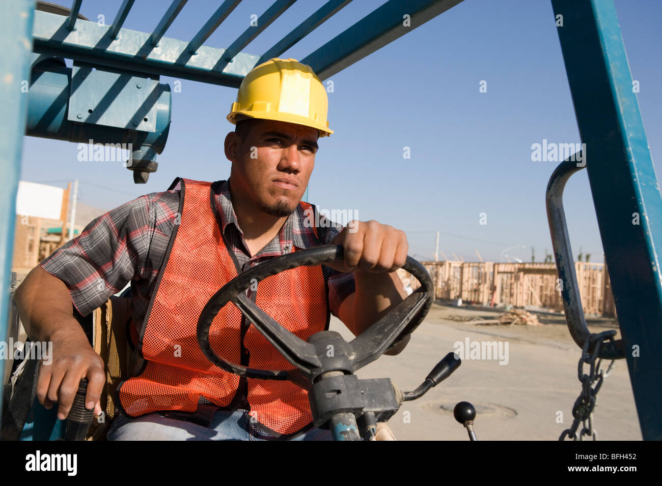 Construction worker driving vehicle Stock Photo - Alamy