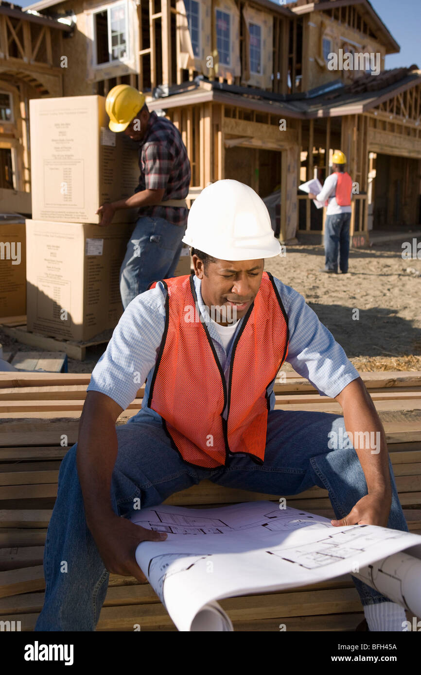 Construction worker showing direction to another worker steering ...