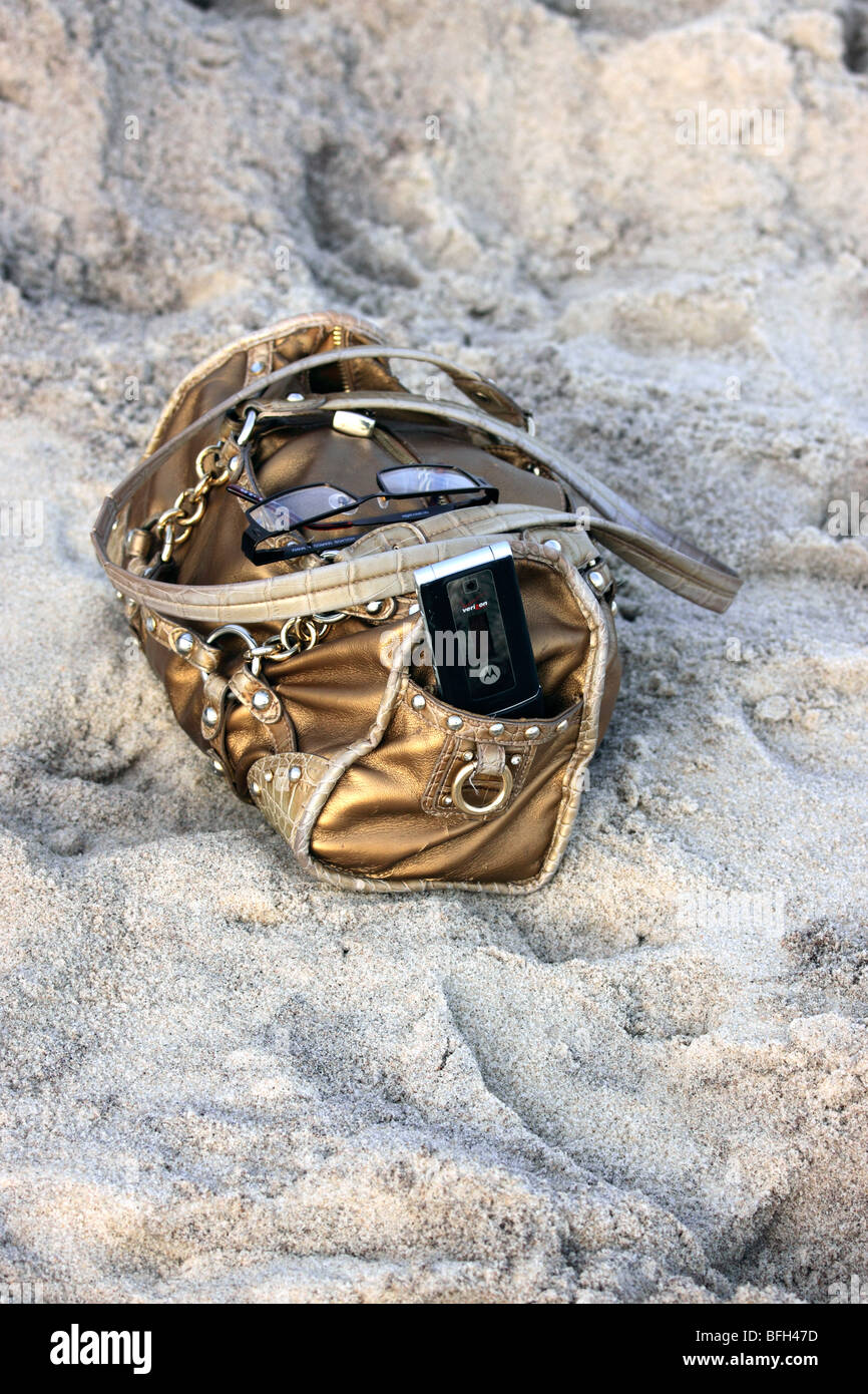 Woman's pocketbook on beach, Long Island, NY Stock Photo - Alamy