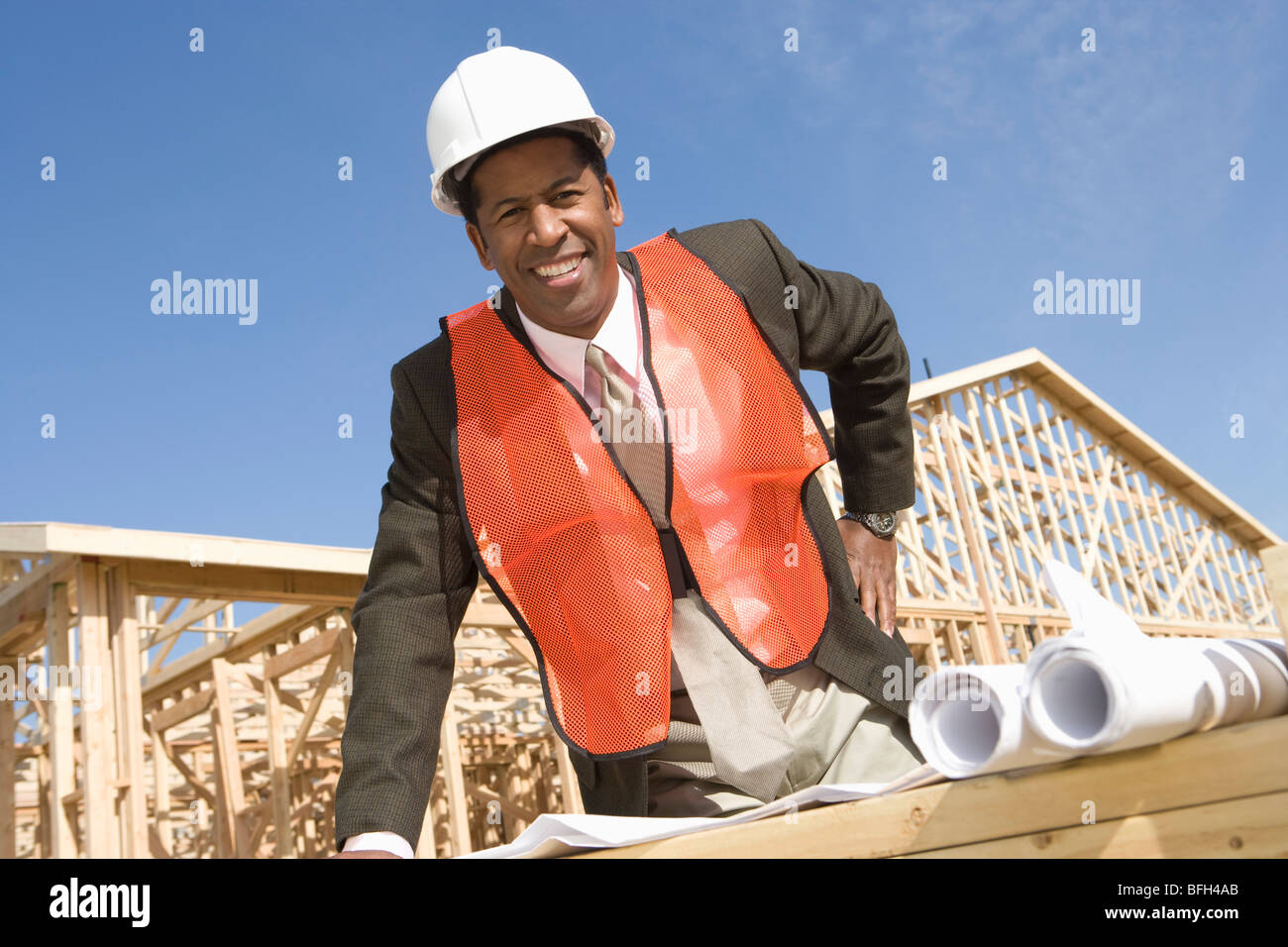 Architect leaning to table with blueprints Stock Photo - Alamy
