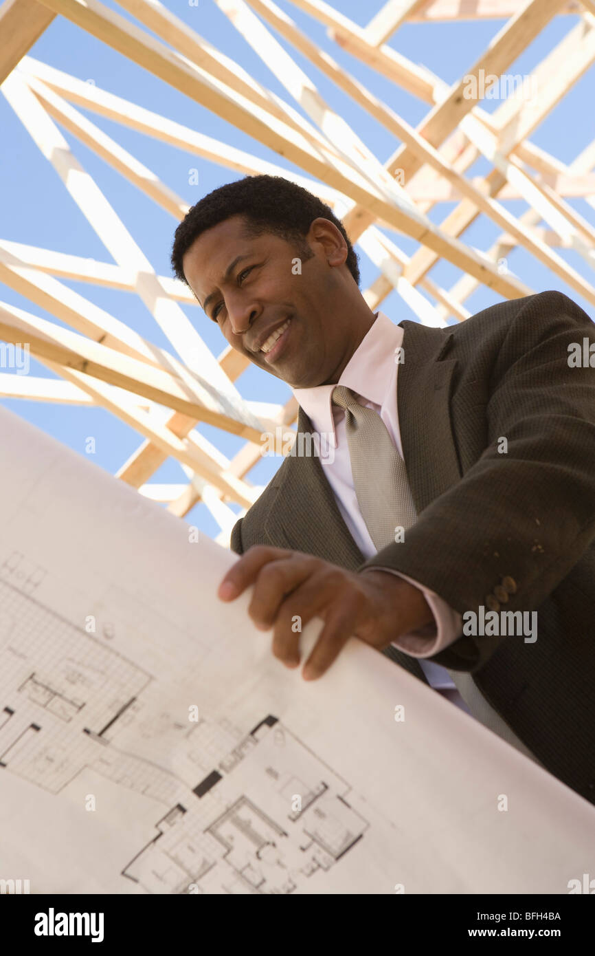 Architect looking at blueprints Stock Photo - Alamy