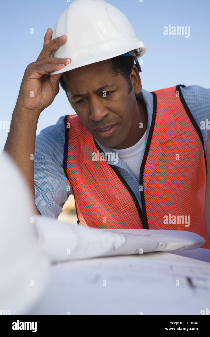 Architect looking at blueprints Stock Photo - Alamy
