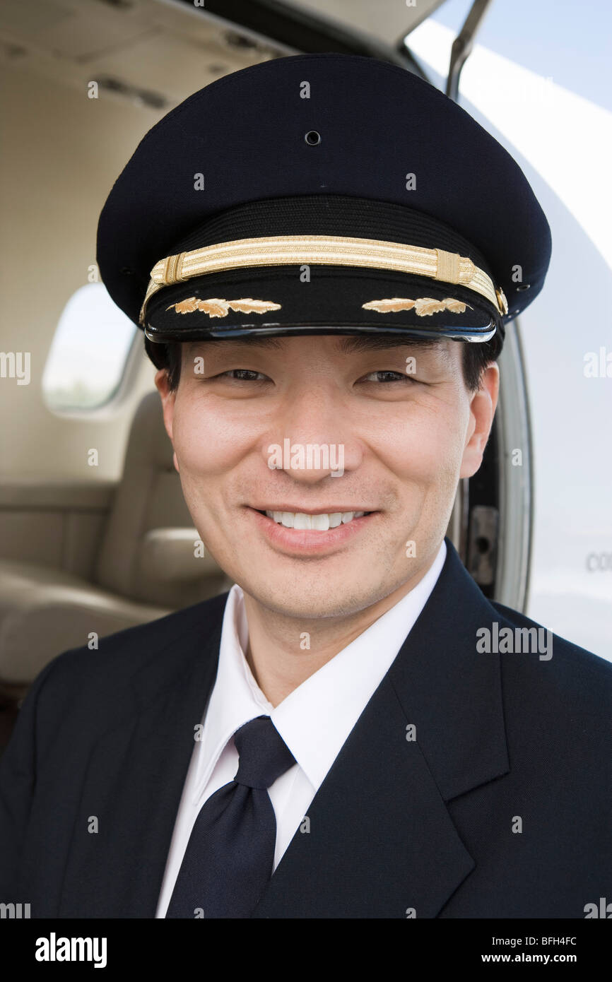 Portrait of Asian male pilot in front of private jet Stock Photo - Alamy