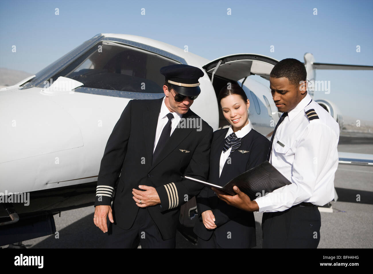 Aeroplane crew on runway Stock Photo - Alamy