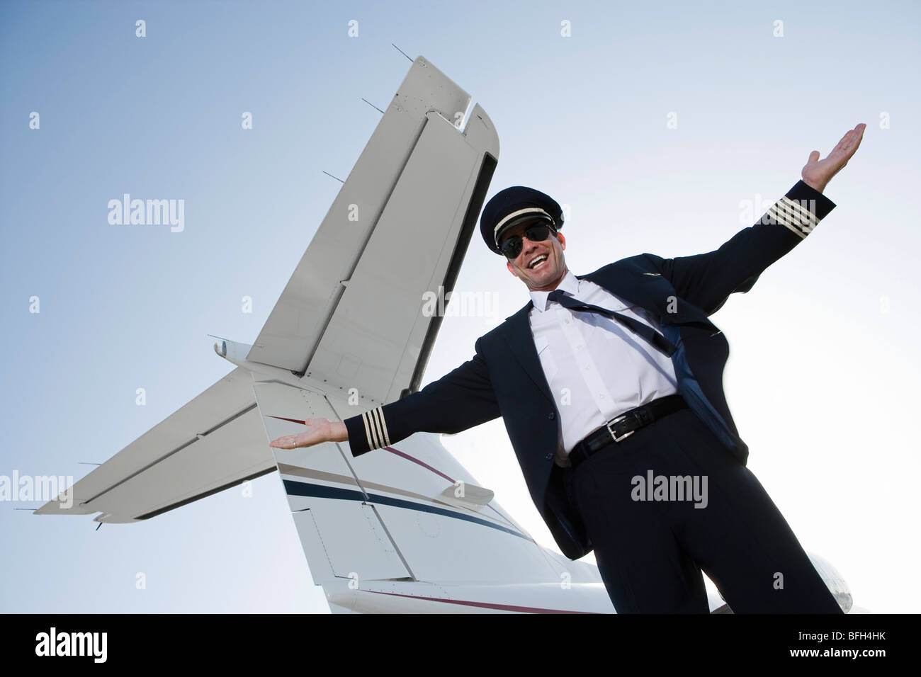 Portrait of pilot standing in front of airplane Stock Photo - Alamy