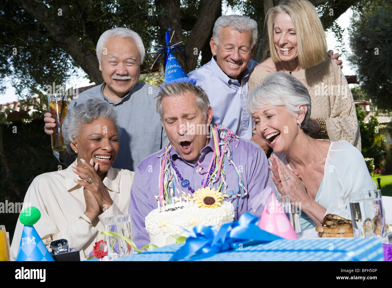 Senior couples celebrating birthday party in garden Stock Photo - Alamy