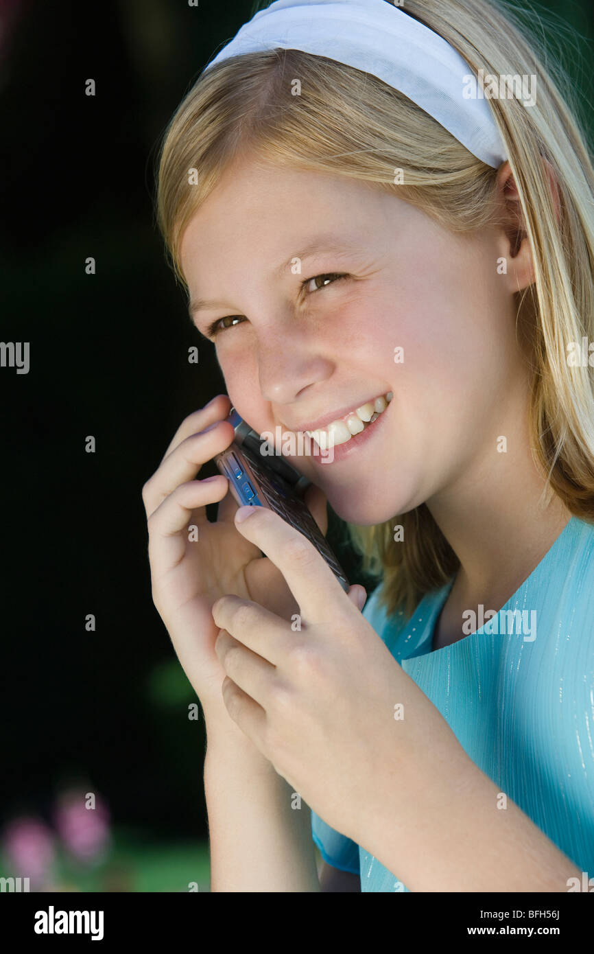 Girl with mobile phone, smiling Stock Photo - Alamy