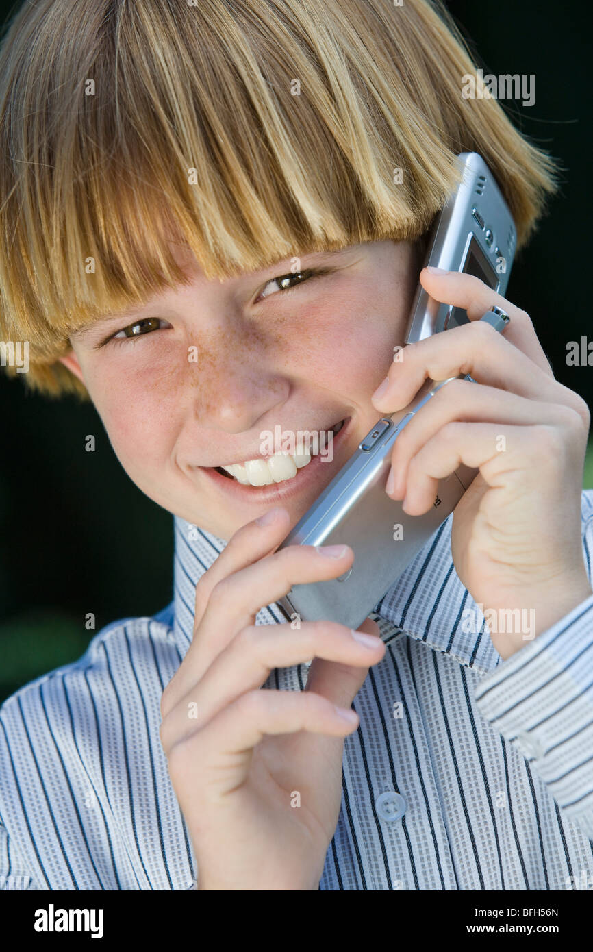 Boy with mobile phone, smiling Stock Photo - Alamy
