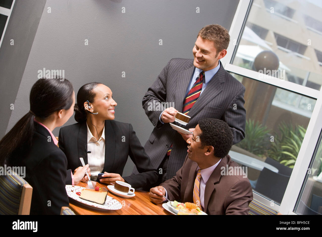 Four business people having lunch Stock Photo - Alamy
