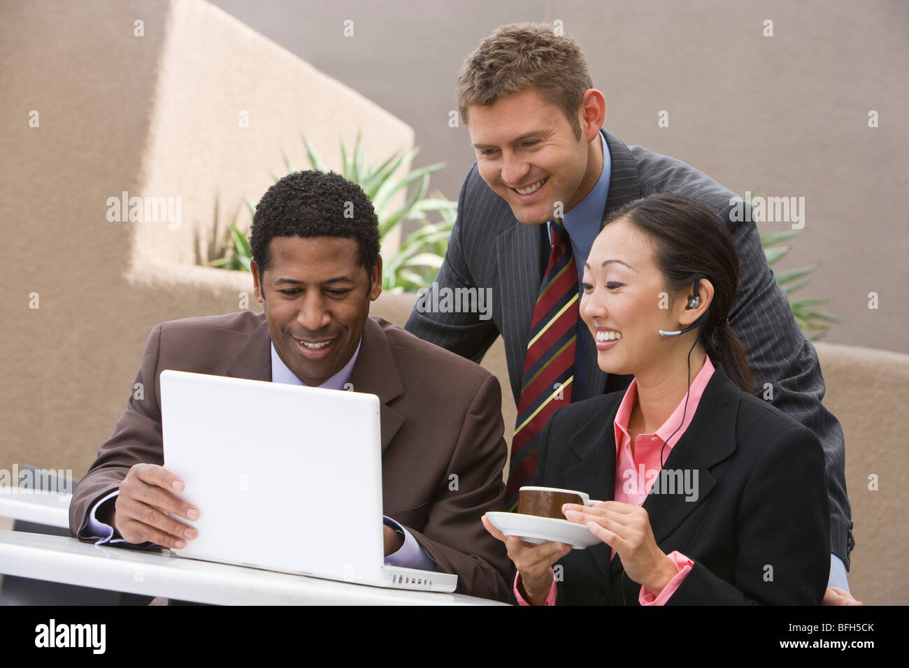 Three business people having meeting Stock Photo - Alamy