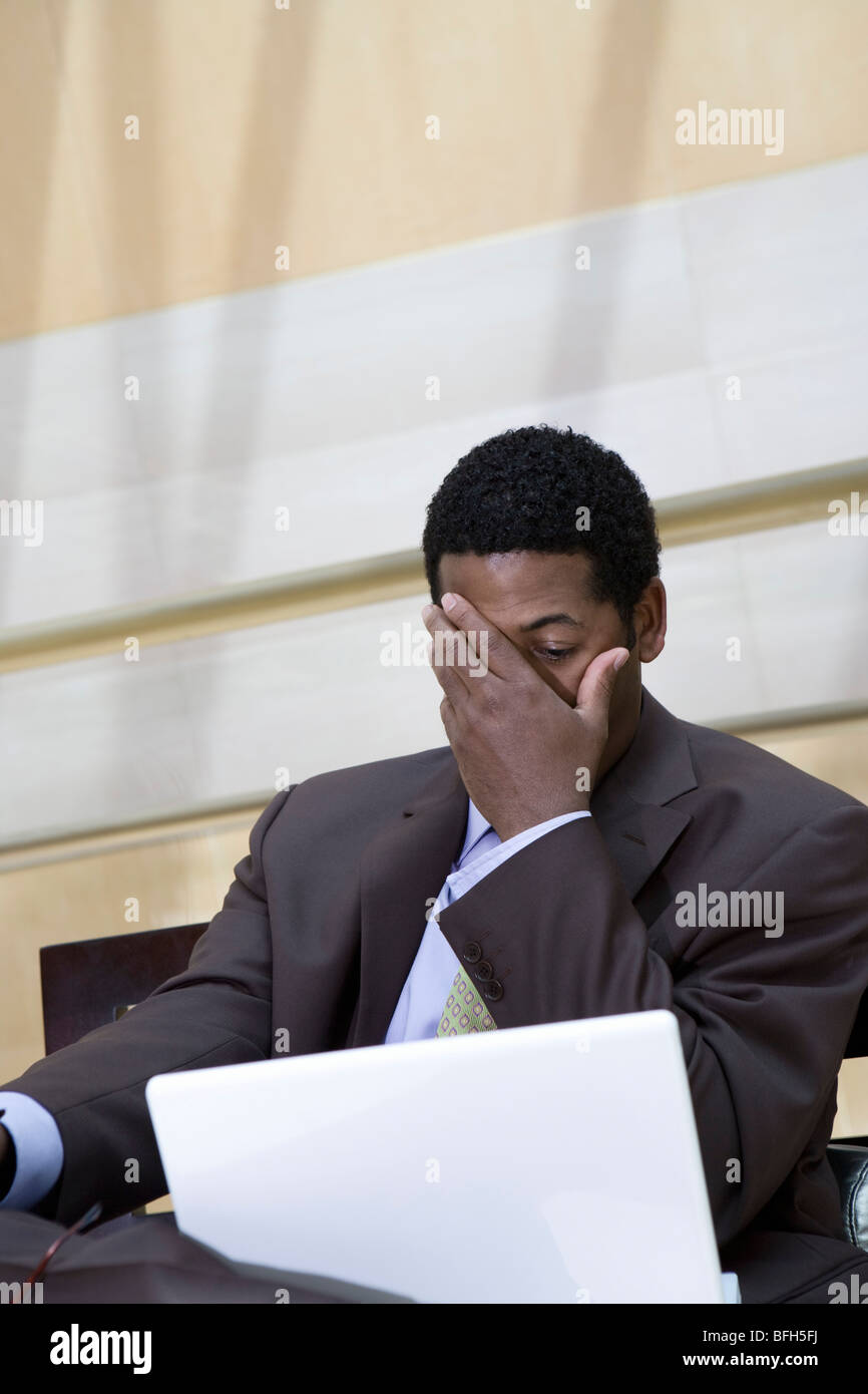 Business man with head in hands Stock Photo - Alamy