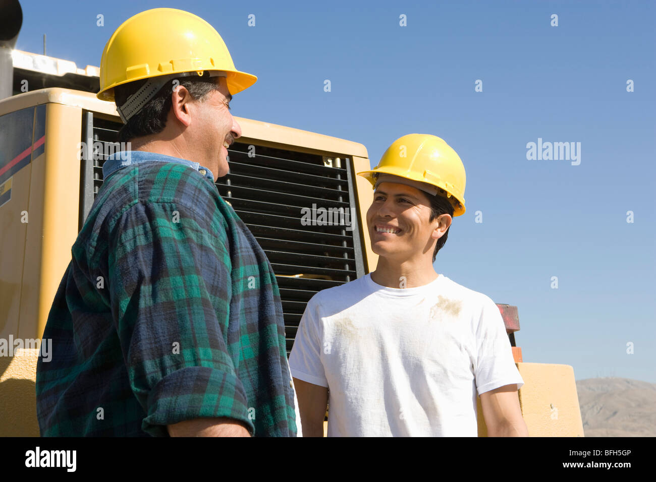 Construction Workers talking and smiling Stock Photo - Alamy