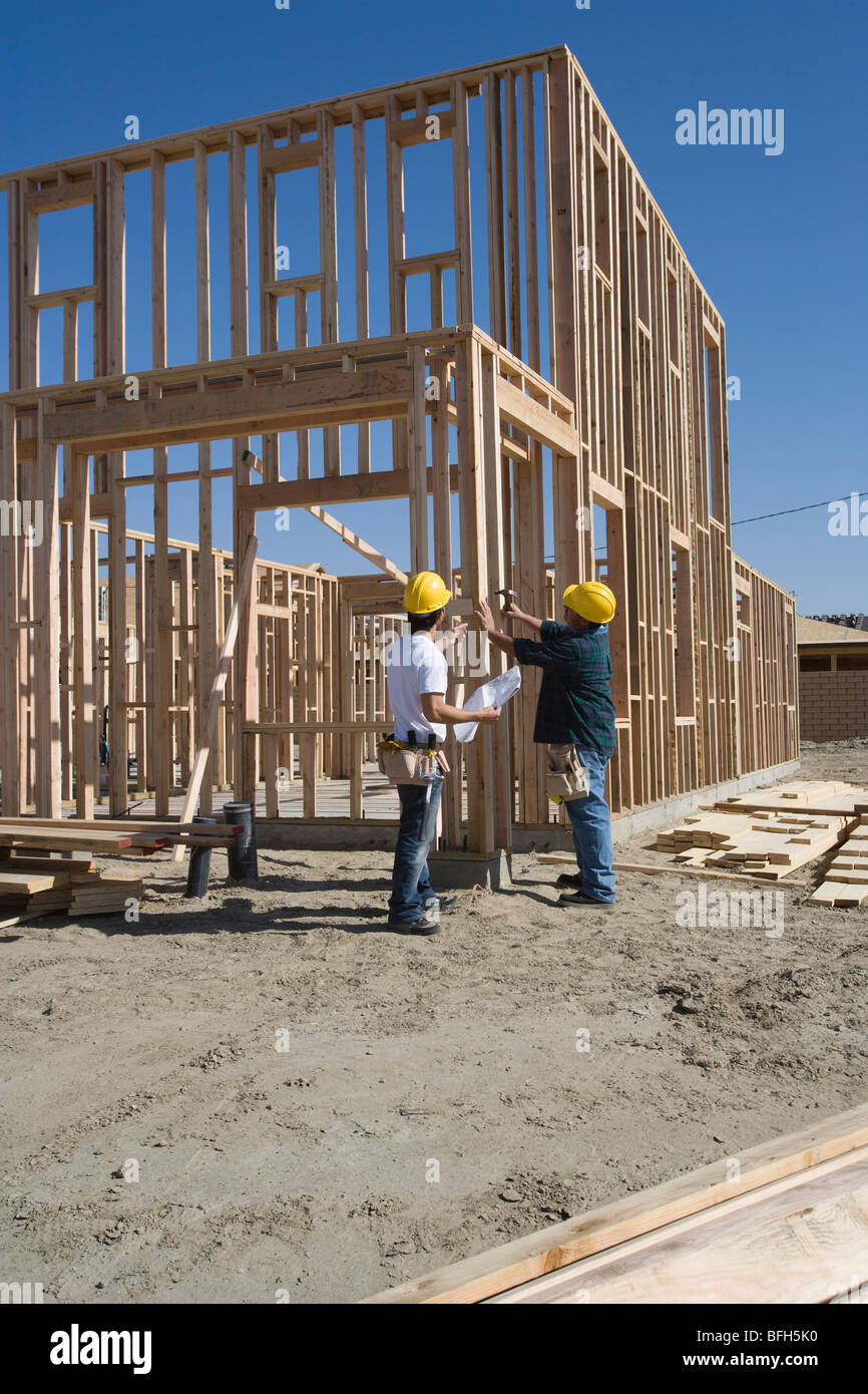 Construction workers on building site Stock Photo - Alamy