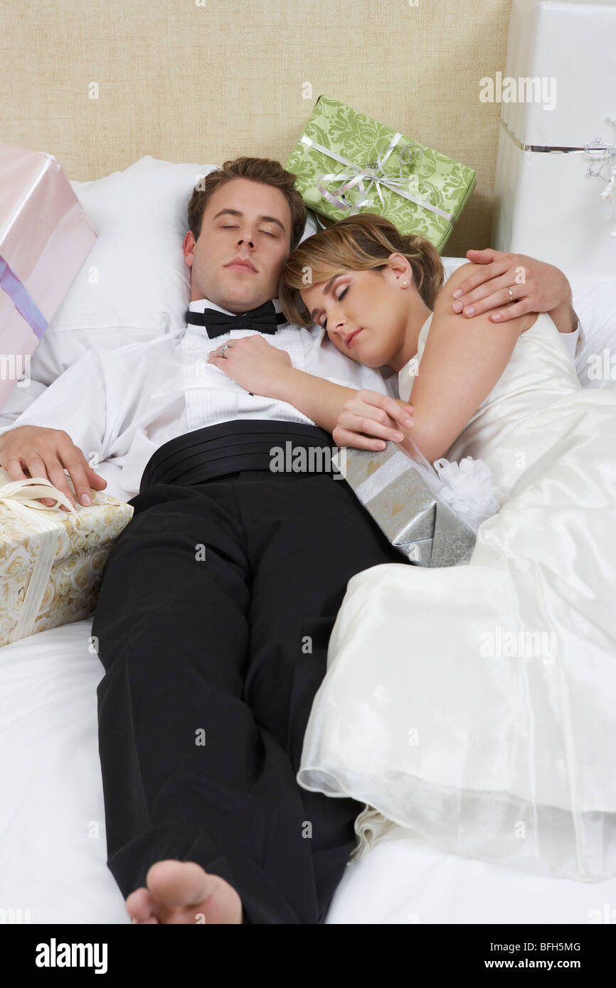Bride and groom sleeping among presents Stock Photo - Alamy
