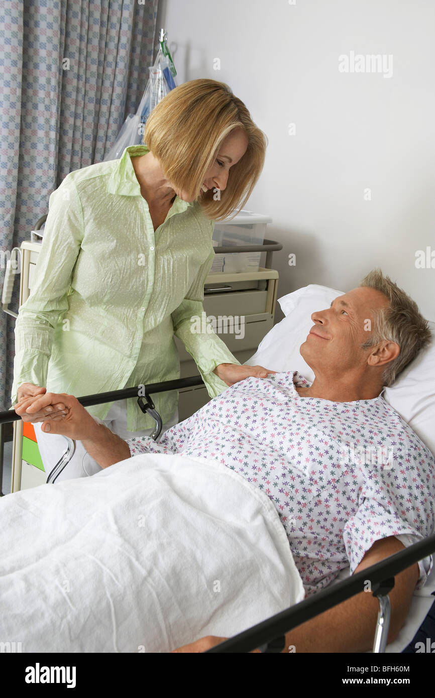 Woman visiting man in hospital Stock Photo - Alamy