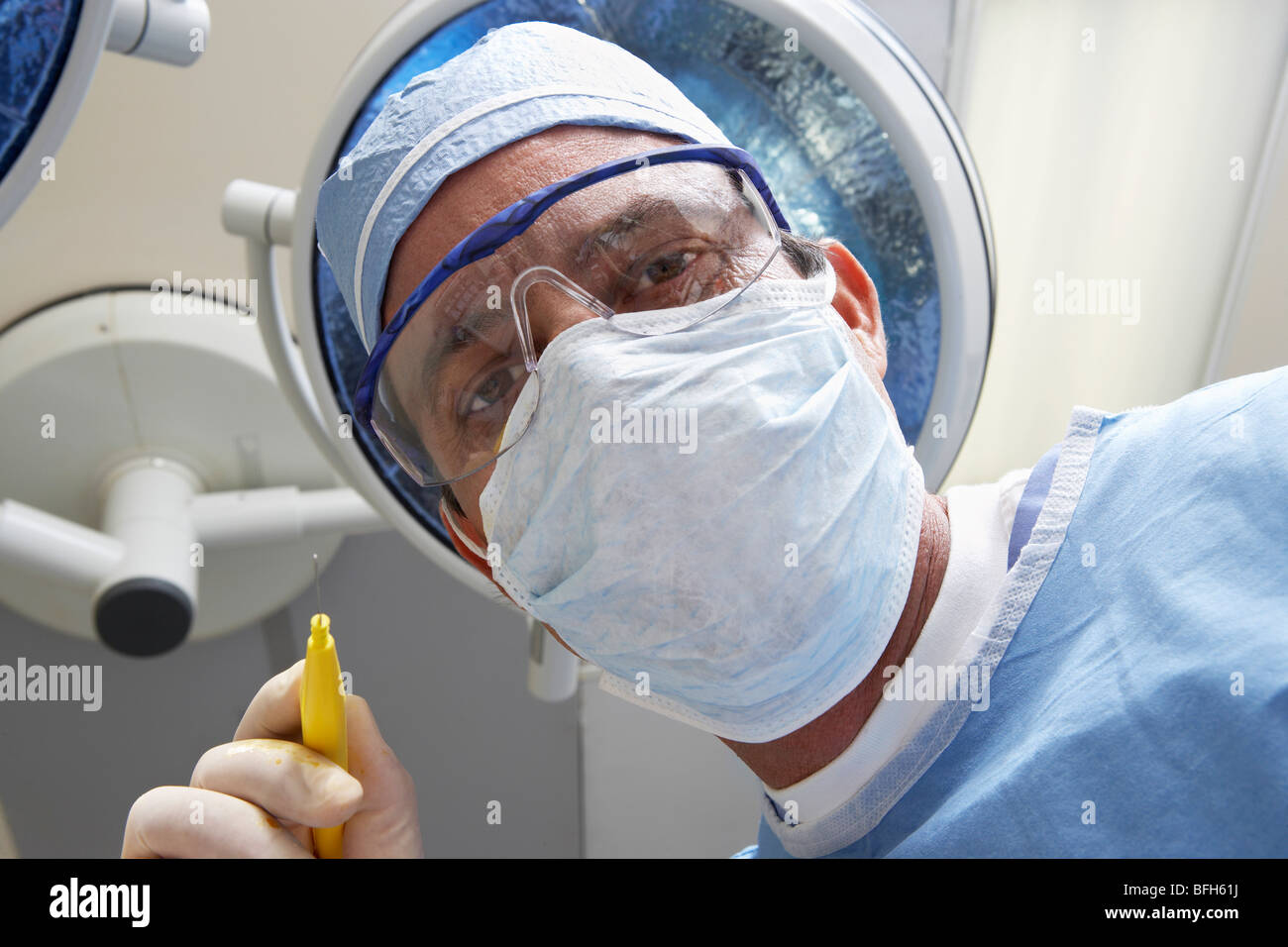 Surgeon looking down, low angle view Stock Photo - Alamy