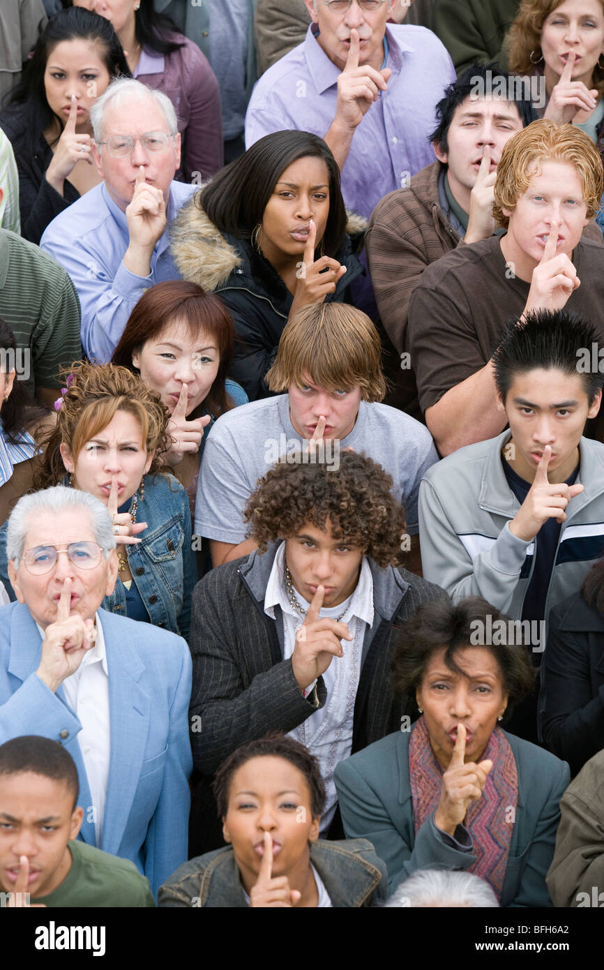 Crowd gesturing silence Stock Photo - Alamy