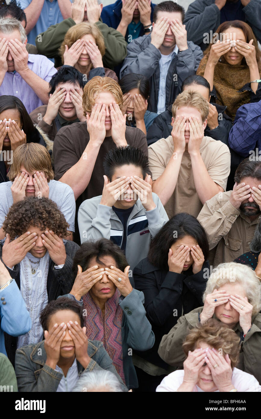 Crowd covering eyes Stock Photo - Alamy