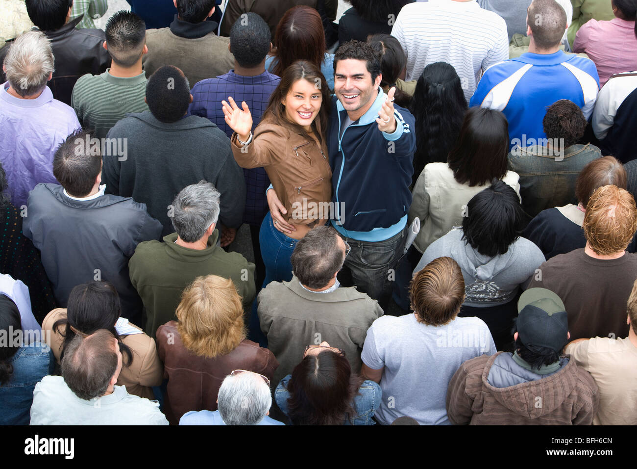 Young couple embracing among crowd Stock Photo - Alamy Young couple embracing among crowd Stock Photo - Alamy
