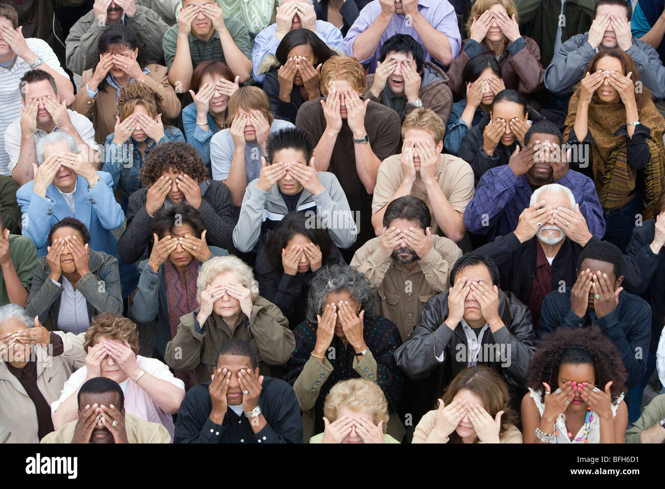 Crowd covering eyes Stock Photo - Alamy