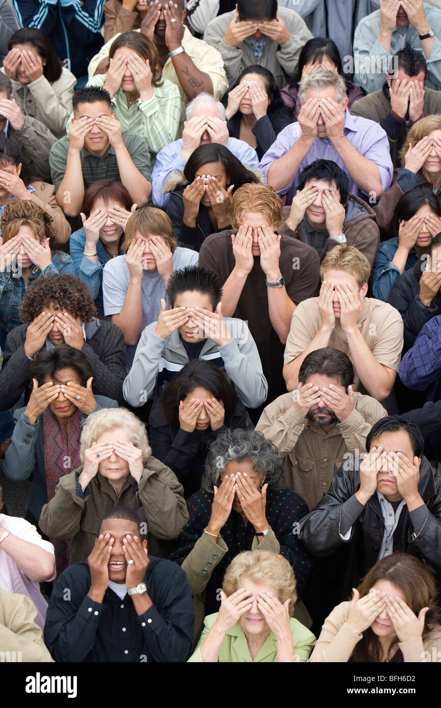 Crowd covering eyes Stock Photo - Alamy