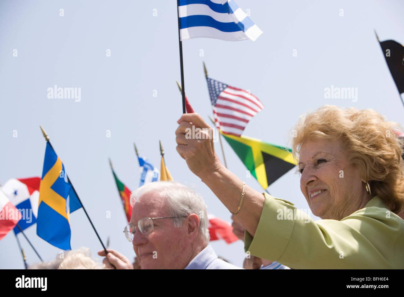 Crowd holding up National flags Stock Photo - Alamy