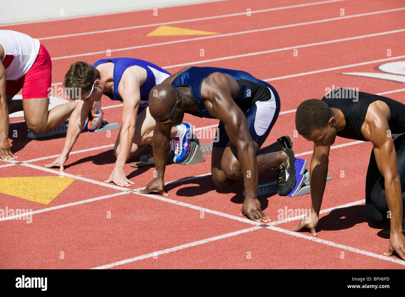 Male sprinters in starting blocks hi-res stock photography and images ...