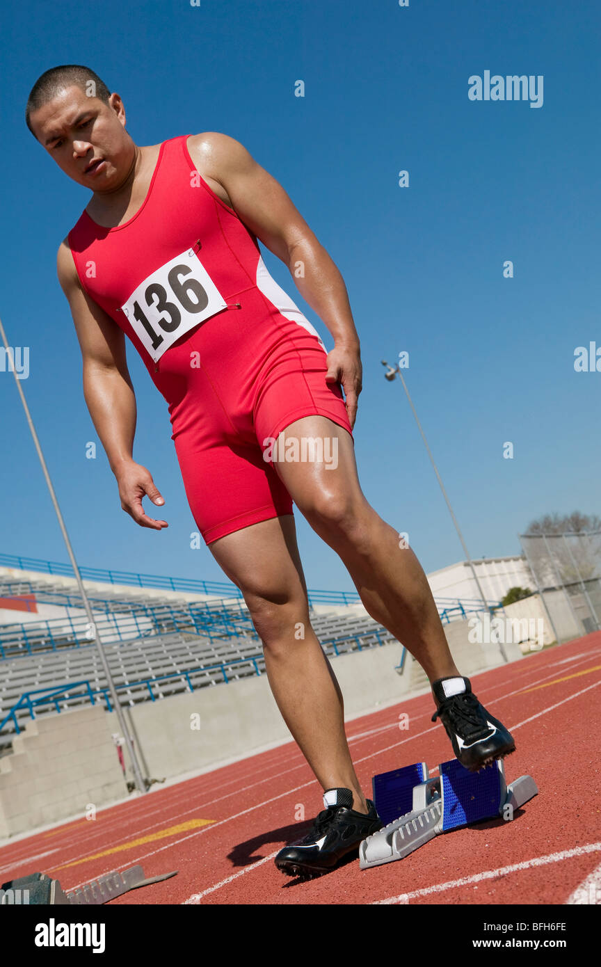 Male sprinter preparing to start Stock Photo - Alamy