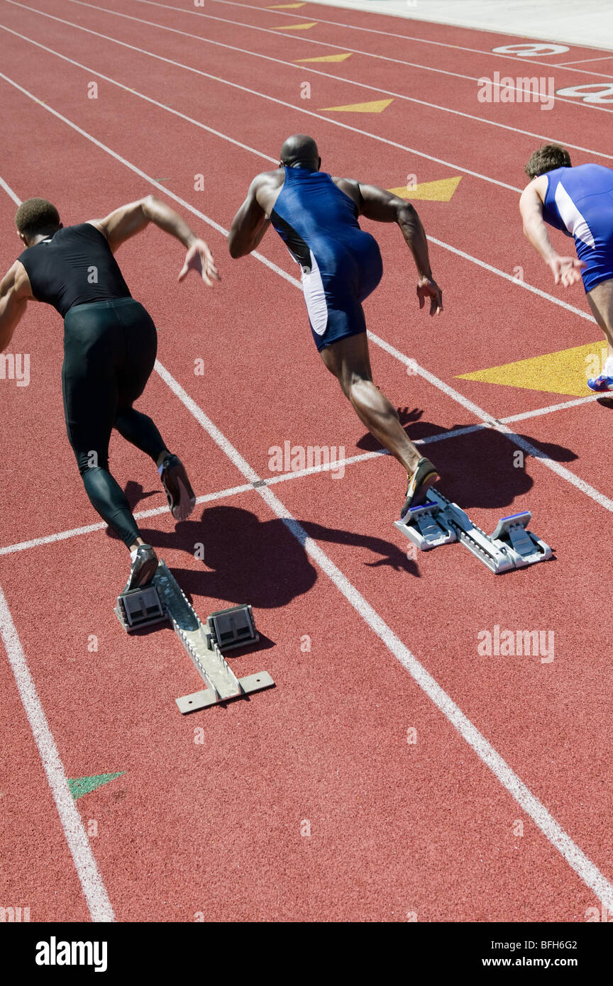 Male sprinters leaving starting block hi-res stock photography and ...