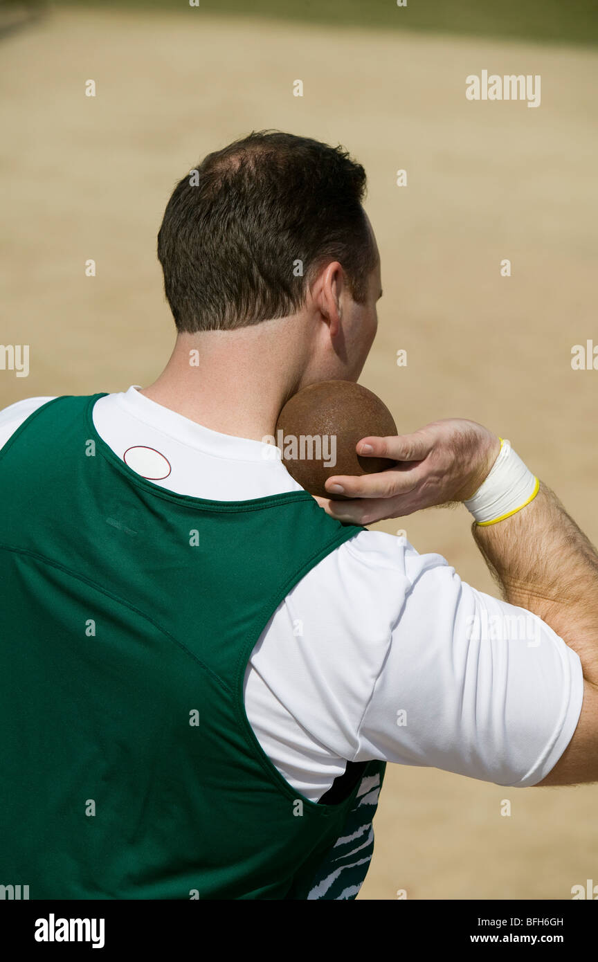 Male shot putter holding shot Stock Photo - Alamy
