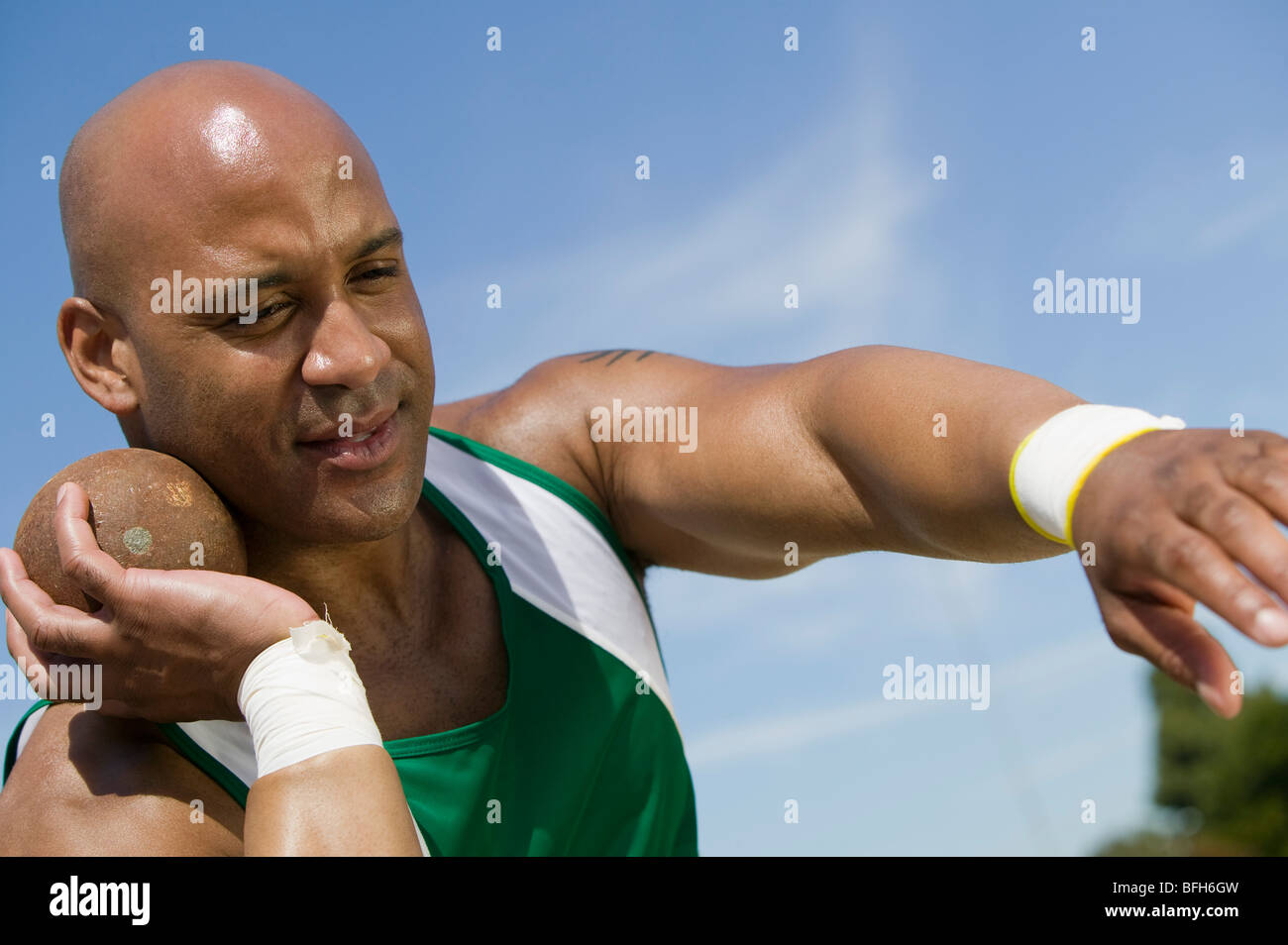 Male shot putter holding shot Stock Photo - Alamy