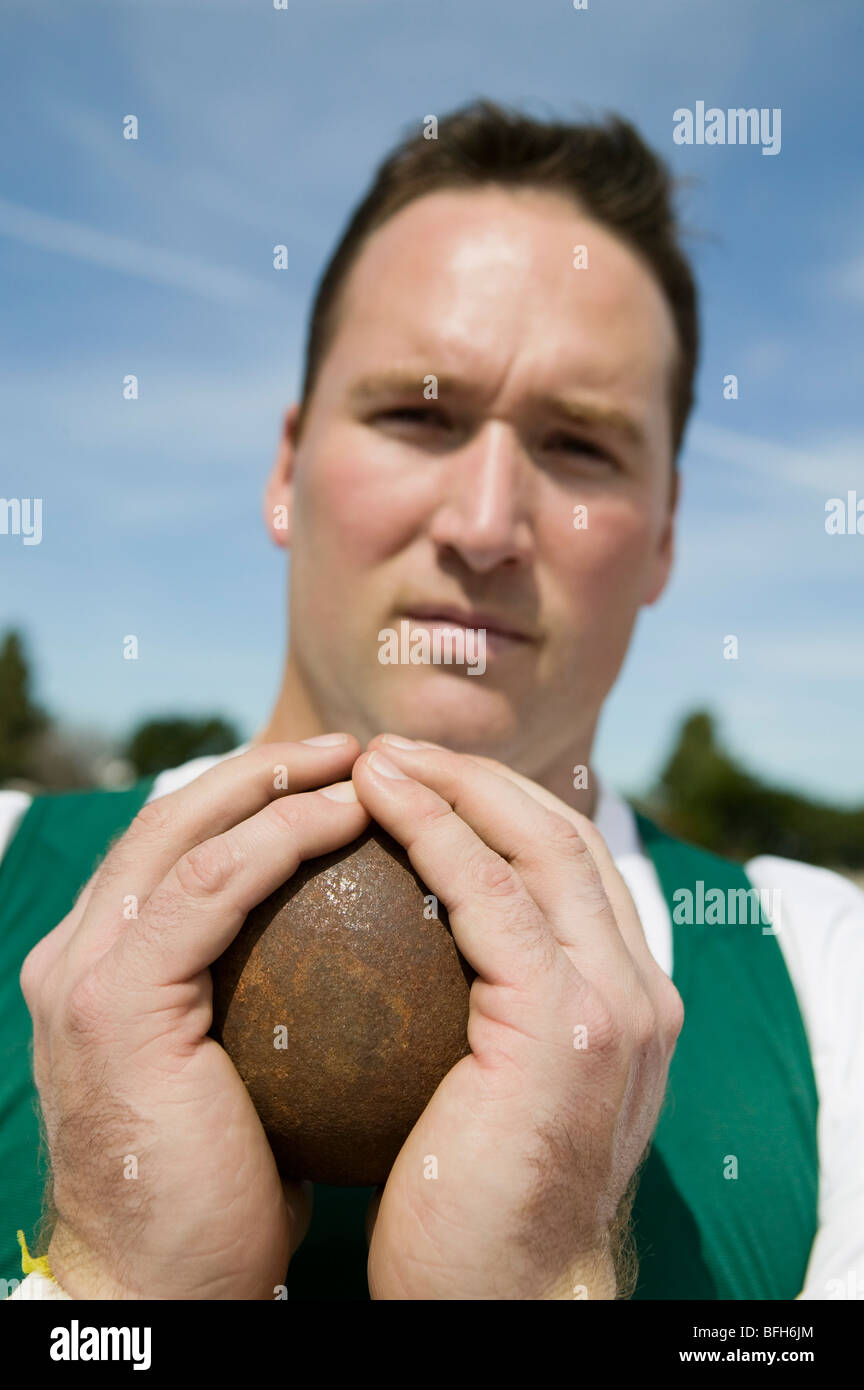 Male shot putter gripping shot, portrait Stock Photo - Alamy