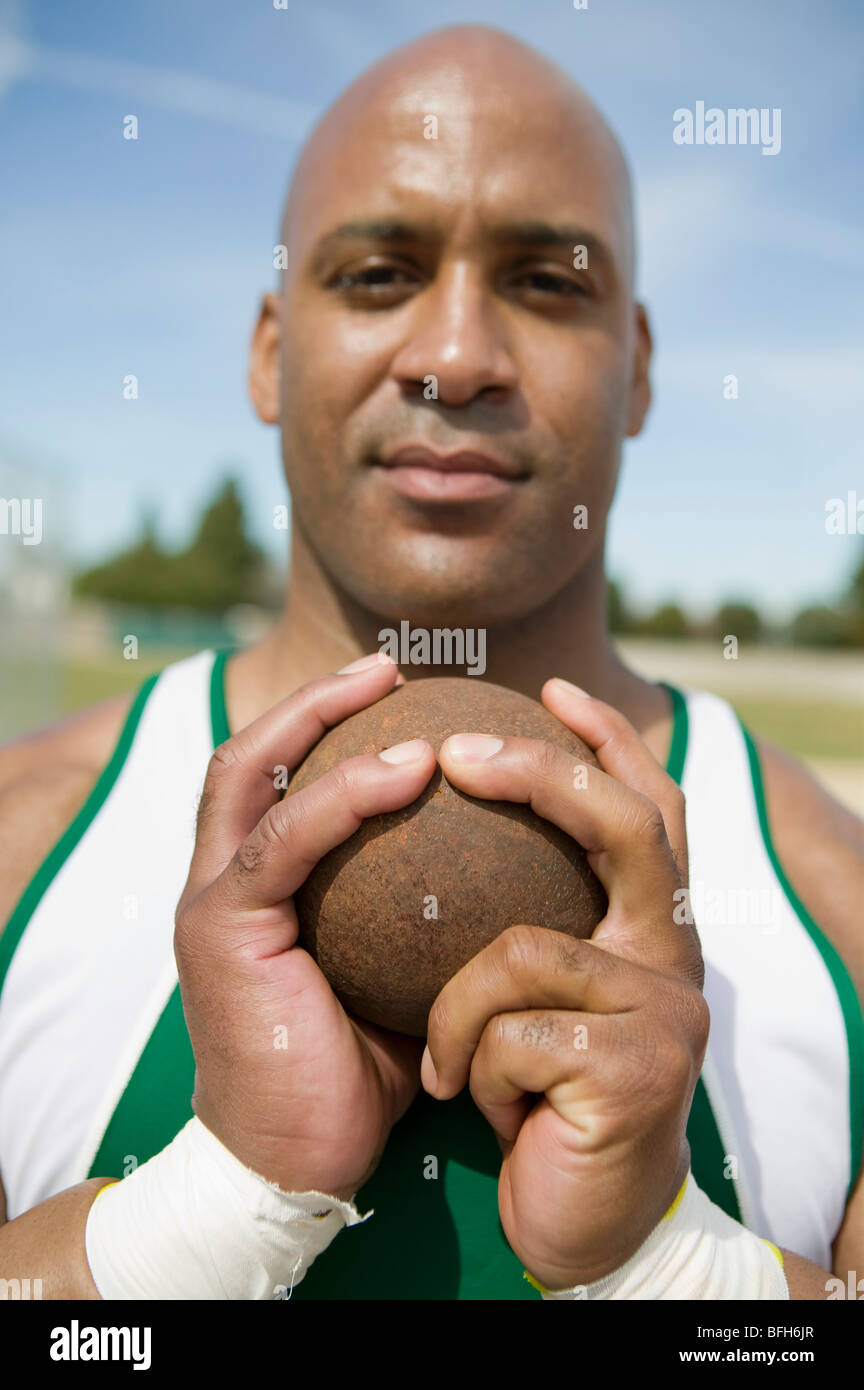 Male shot putter gripping shot, portrait Stock Photo - Alamy