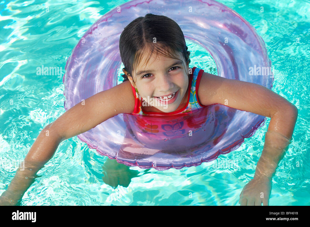 Girl in inflatable raft in swimming pool, portrait Stock Photo - Alamy