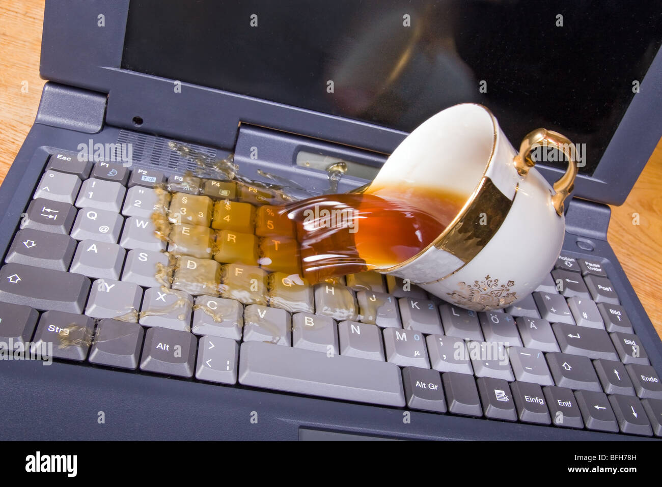 coffee spilling on keyboard Stock Photo - Alamy