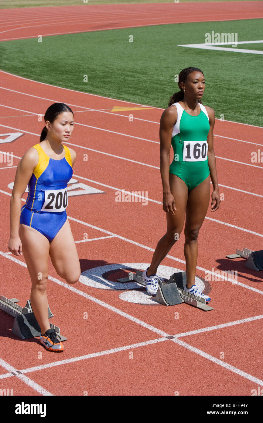 Female athletes next to starting blocks, ready to run Stock Photo - Alamy