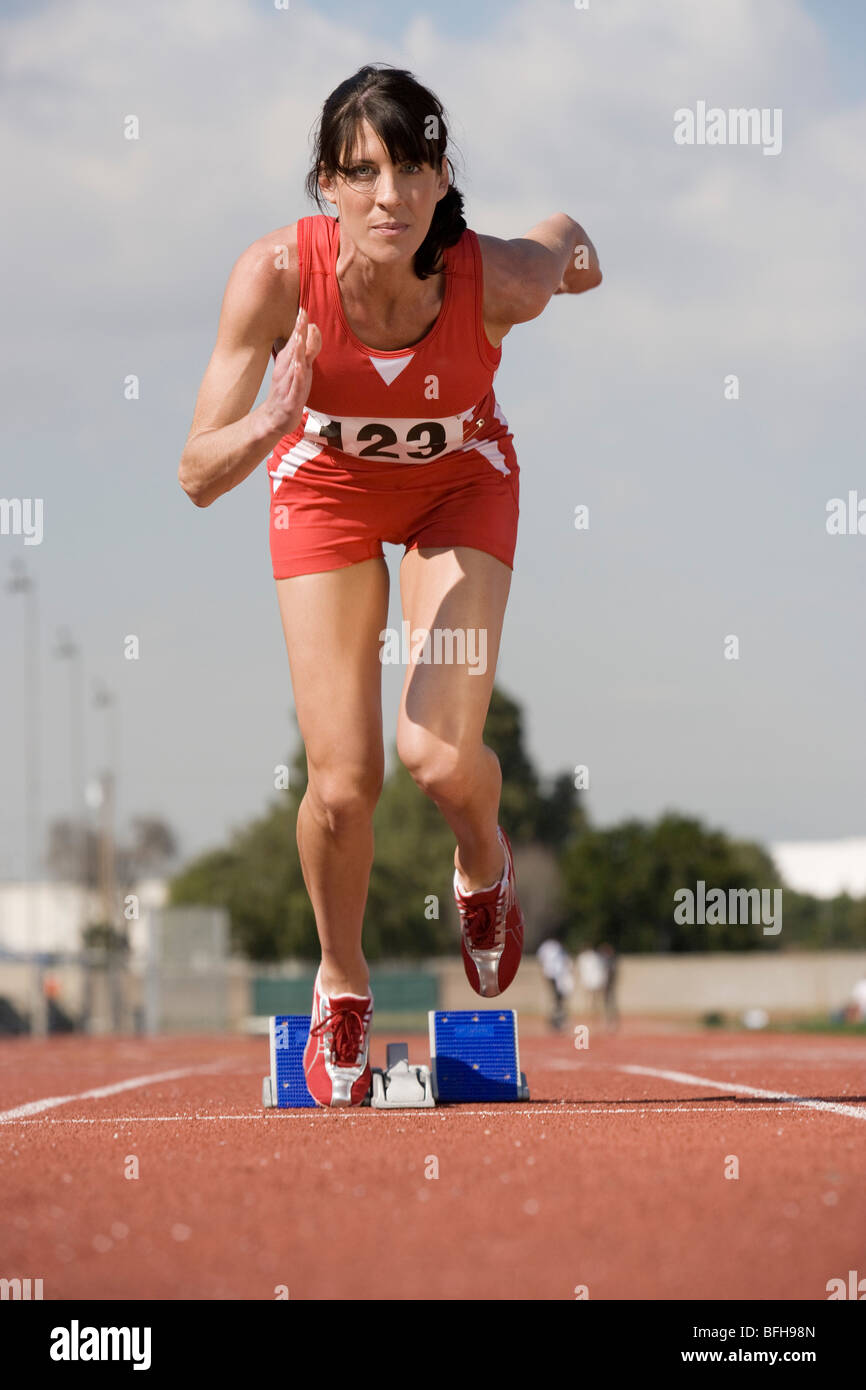 Female athlete starting to run Stock Photo - Alamy