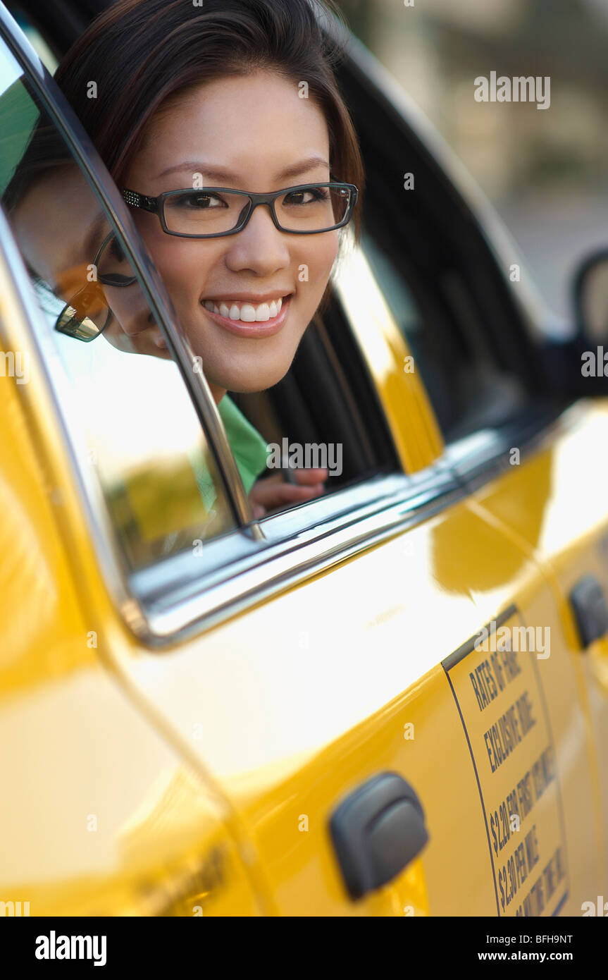 Woman in glasses looking out taxi window Stock Photo - Alamy